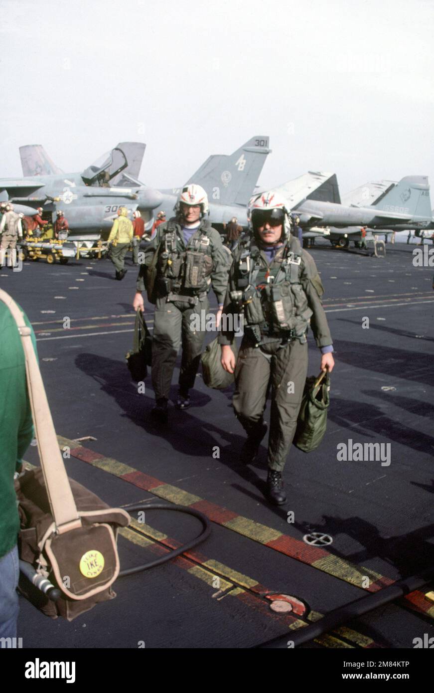 Two pilots head for their aircraft aboard the aircraft carrier USS ...