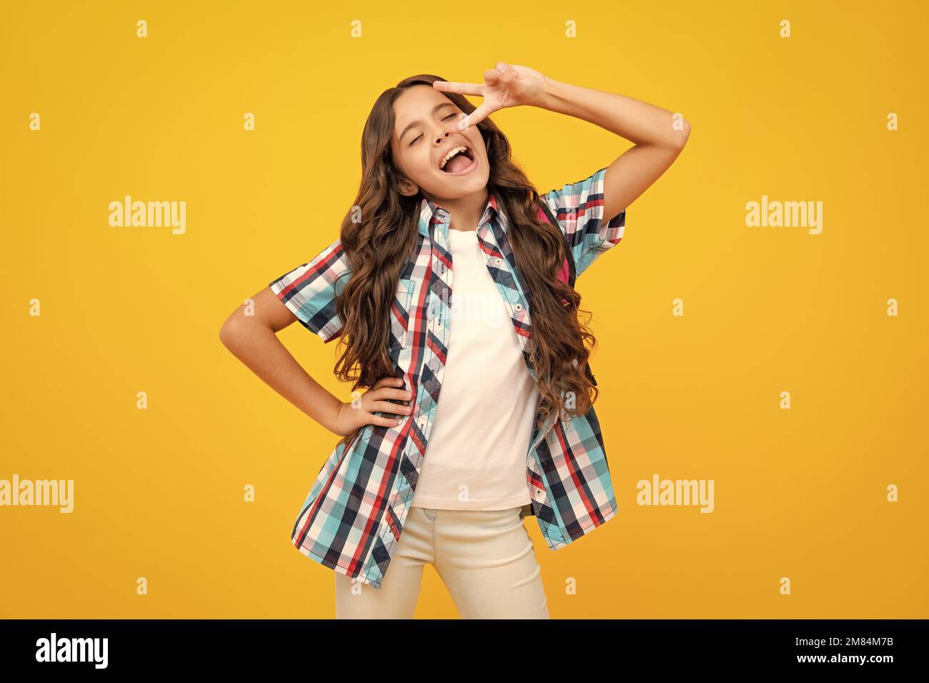 Funny portrait of amazed teenager child girl isolated on yellow ...