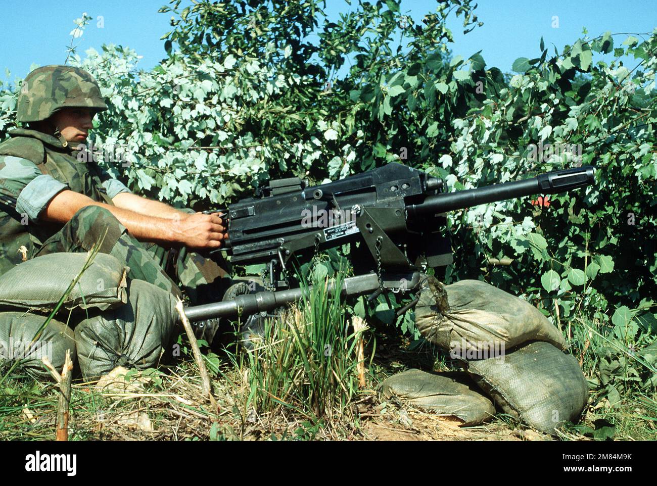 A Marine demonstrates a Mark 19 Mod 3 40mm machine gun. The gun fires ...