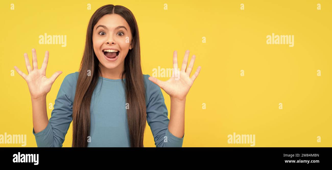 surprised face portrait of child on yellow background. express positive ...