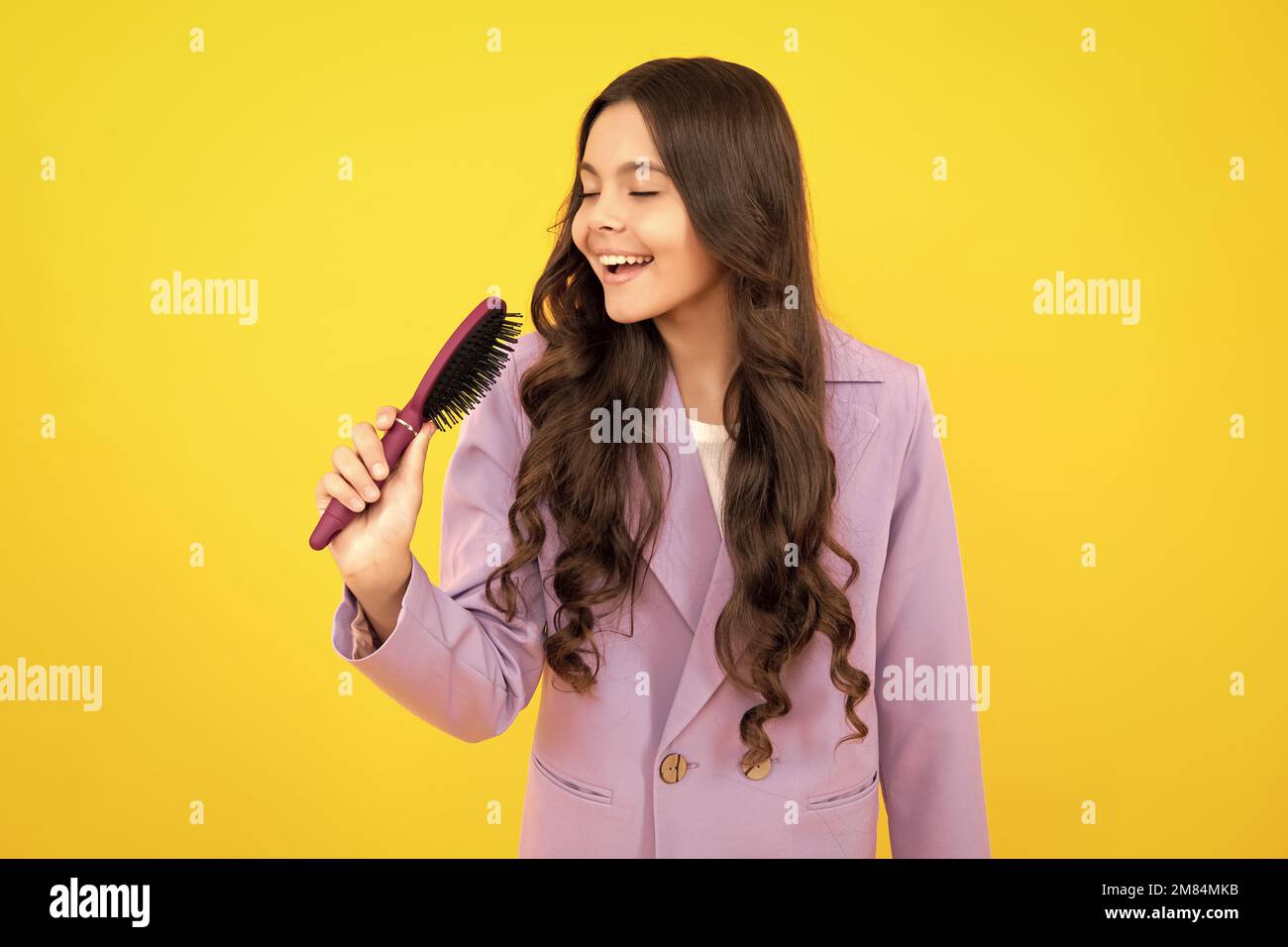 Teenager girl with long hair holding comb hairbrush for combing, beauty ...