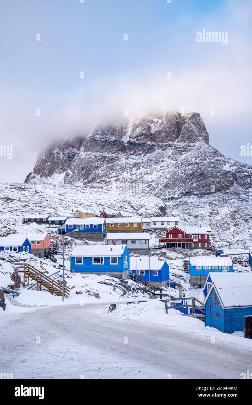 Colourful houses clinging to the side of the mountain at Uummannaq in ...