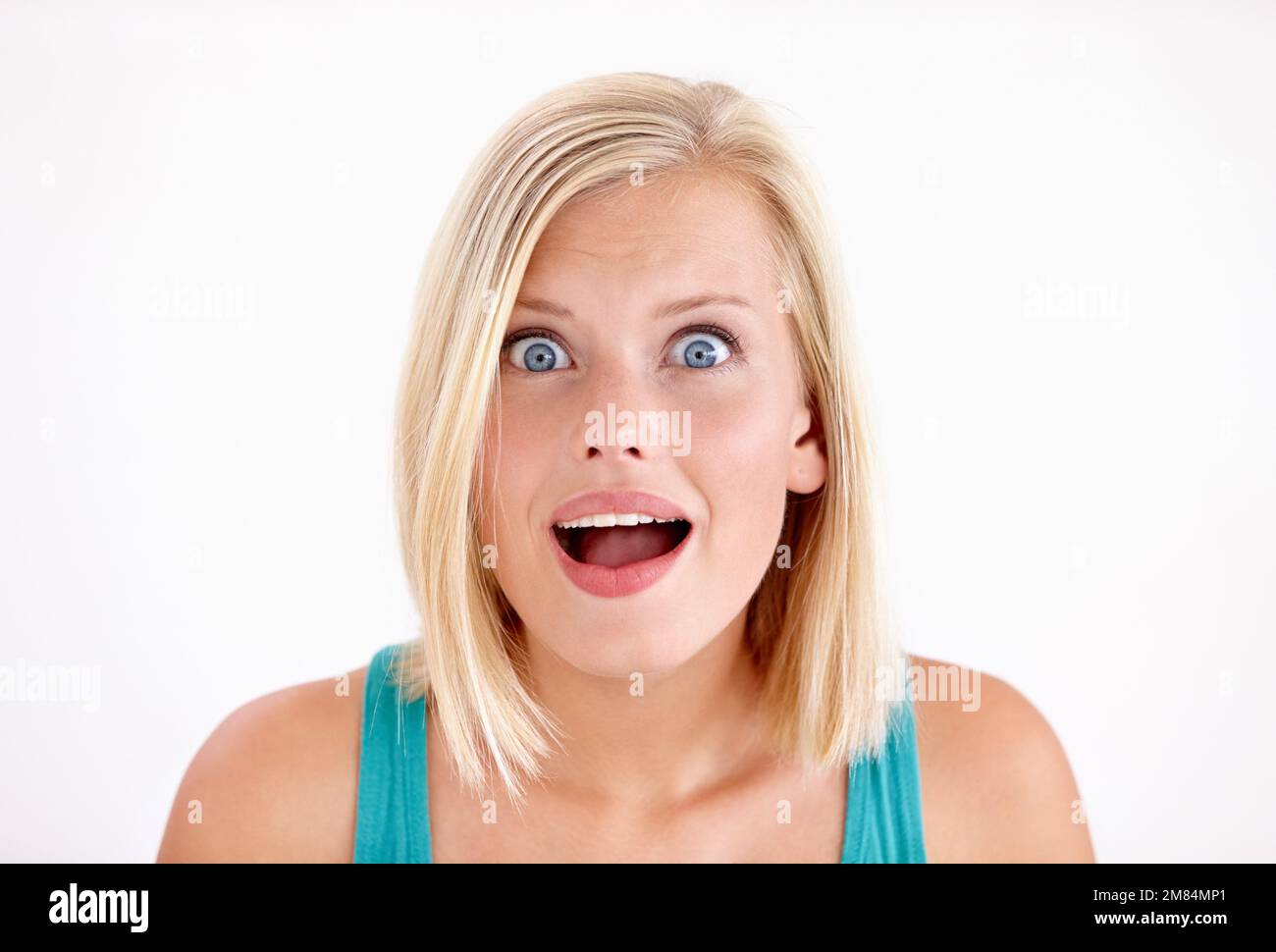 The shock is etched on her face. Portrait of a beautiful young woman looking shocked Stock Photo ...