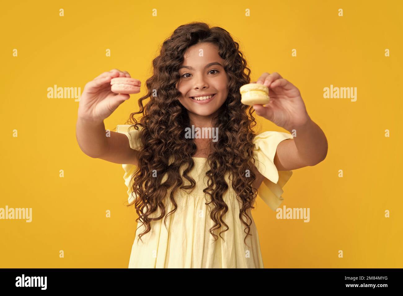 Child girl with dessert bakery. Teenager kid hold french macaron ...