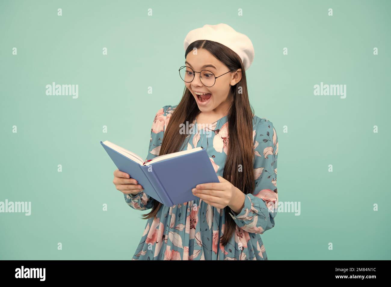 Schoolgirl with copy book posing on isolated background. Literature ...