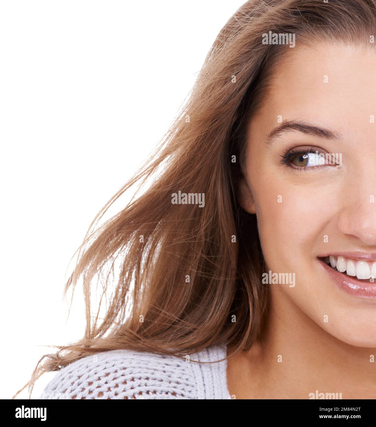 Naturally beautiful. A young woman smiling and looking sideways against ...