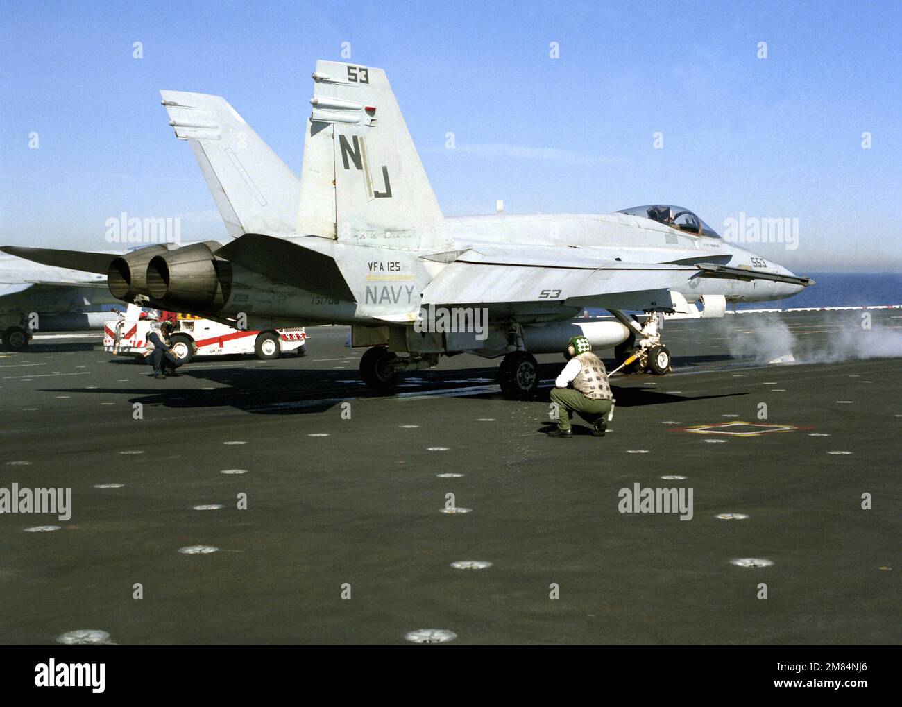 A squadron plane inspector watches as an F/A-18A Hornet aircraft of ...