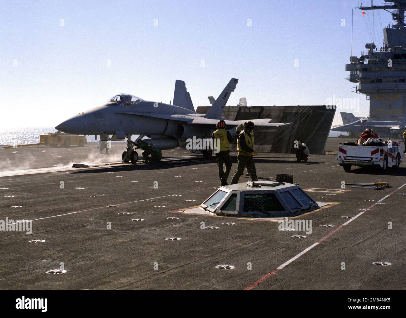 A squadron plane inspector watches as an F/A-18A Hornet aircraft of ...
