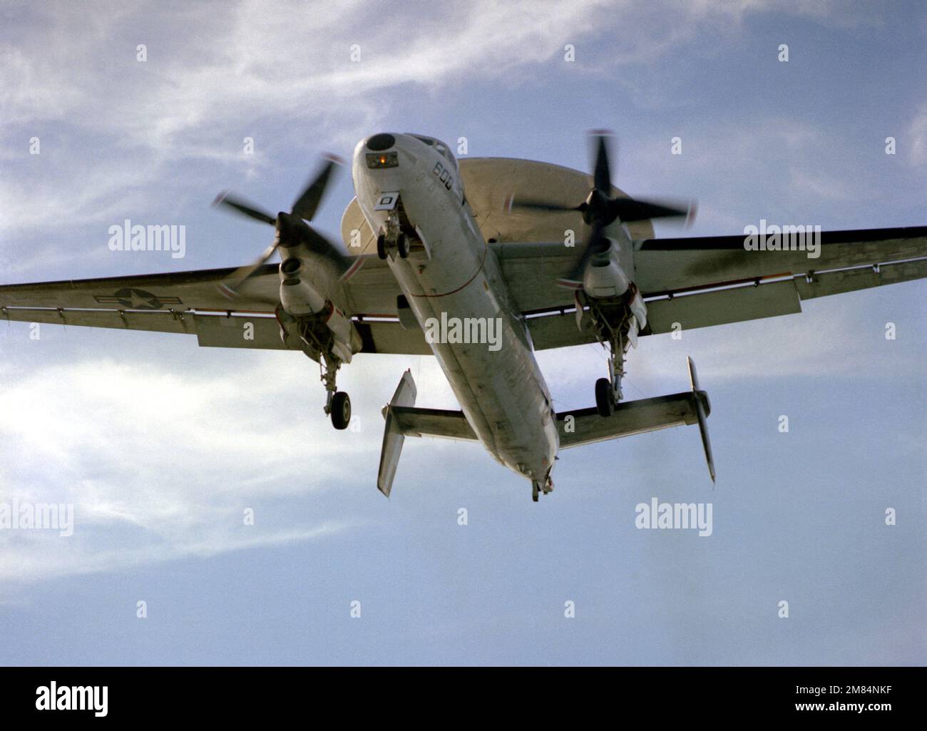 An E-2C Hawkeye aircraft passes over the flight deck of the nuclear ...