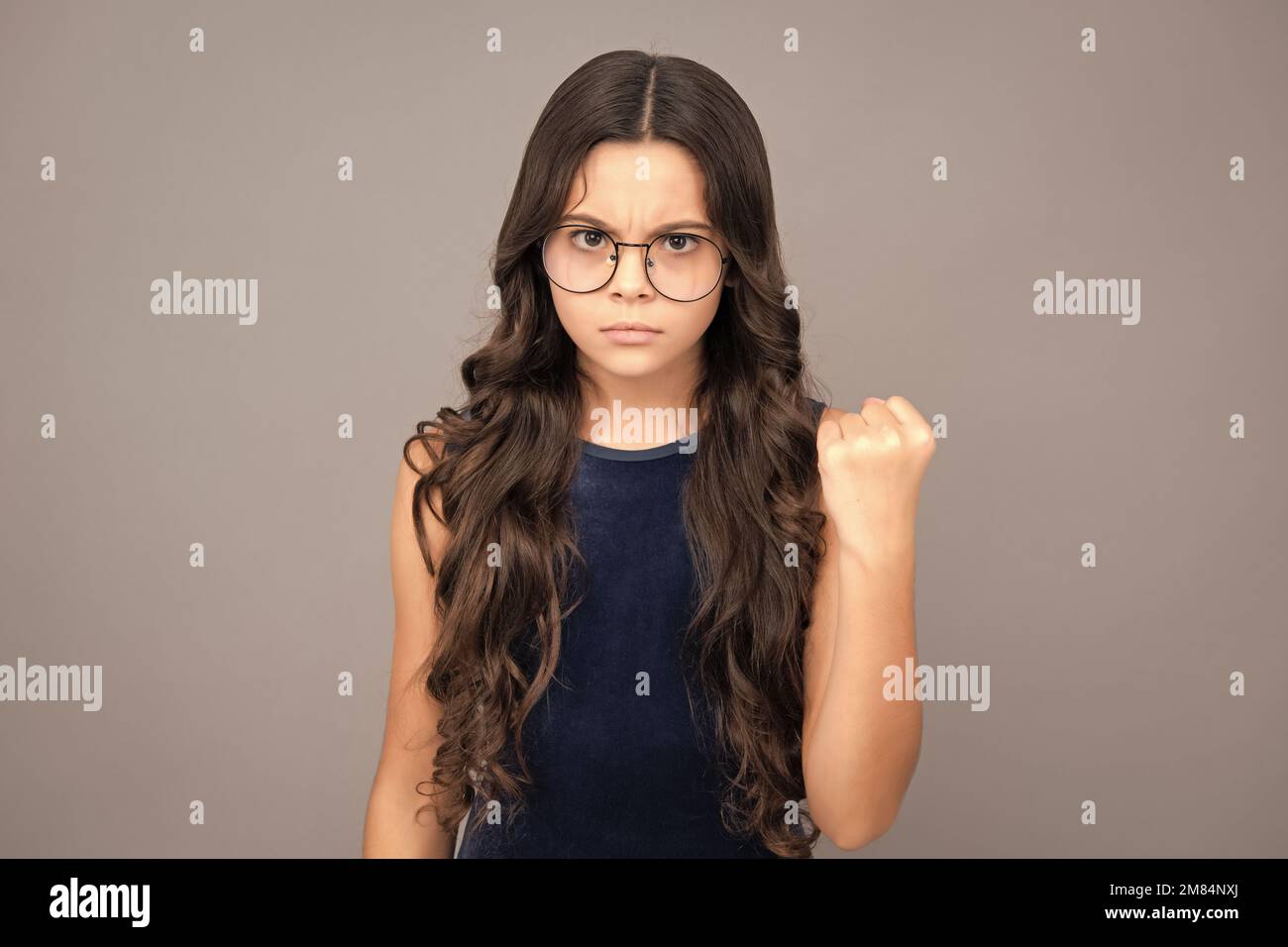 Angry teenager girl, upset and unhappy negative emotion. Studio ...