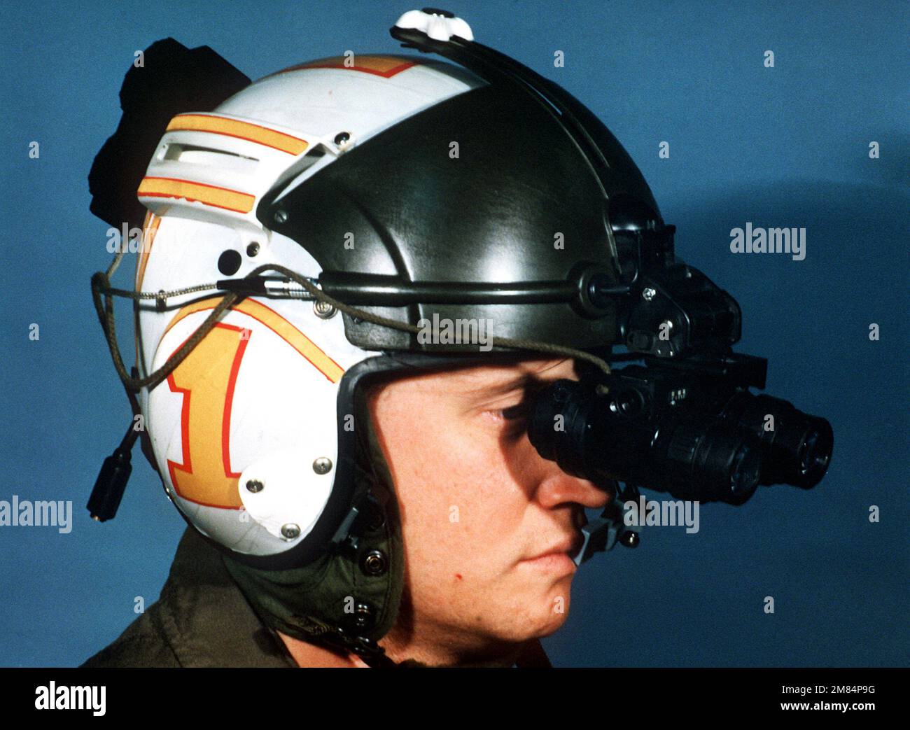 A U. S. Marine wears a flight helmet equipped with the AN/AVS-6(V) aviator's night vision ...