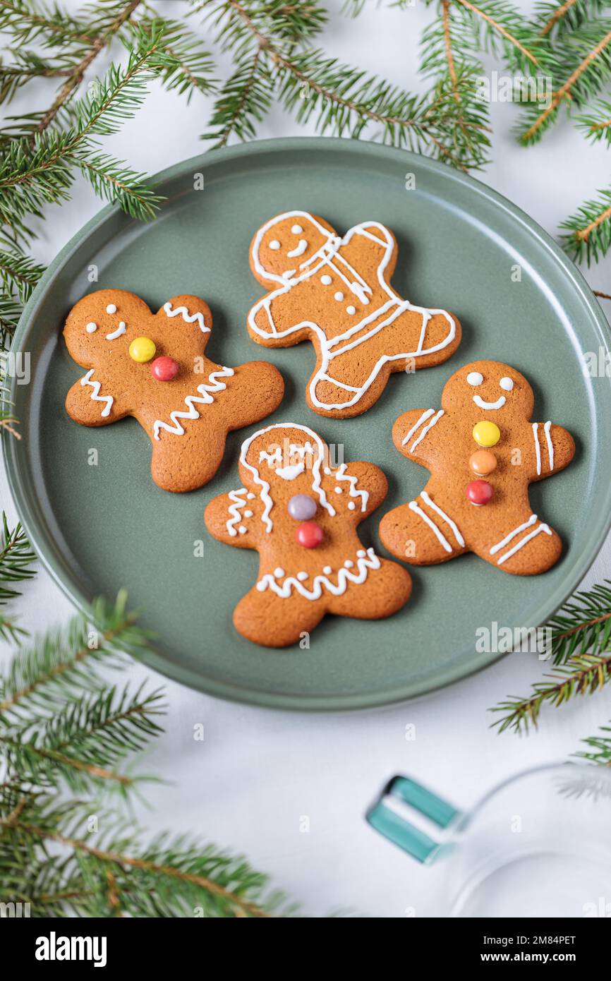Gingerbread cookies in shape of ginger man placed on green plate with ...