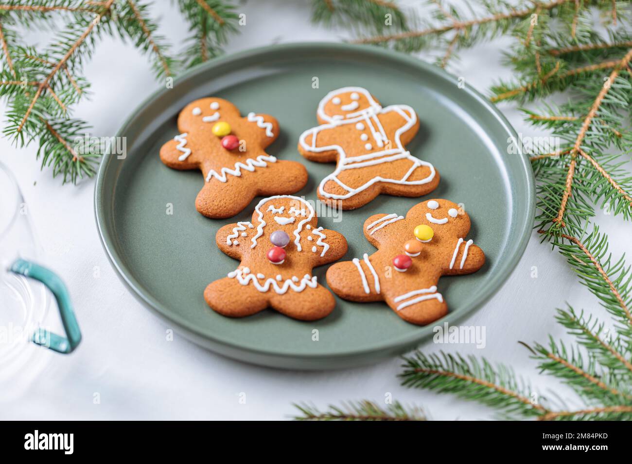 Gingerbread cookies in shape of ginger man placed on green plate with ...