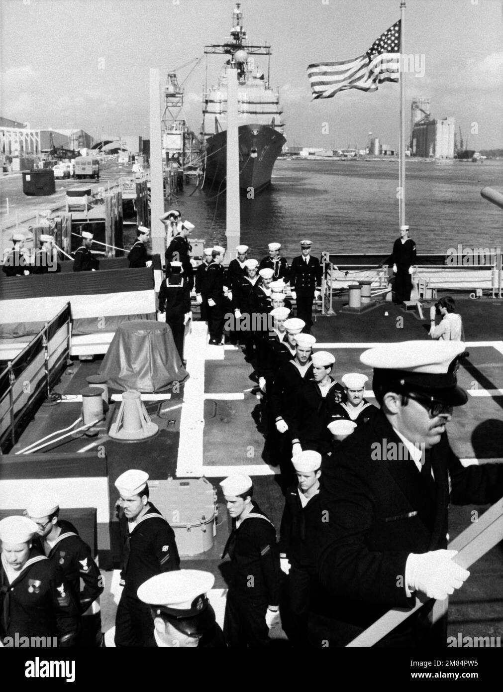 The ship's crew man the ship during the commissioning of the guided ...