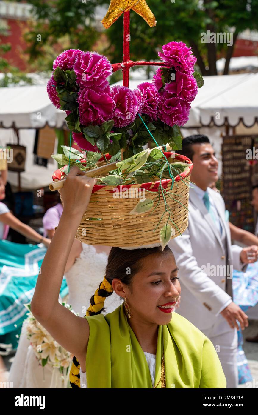 A canastera dancer with her flower basket dances at a wedding ...