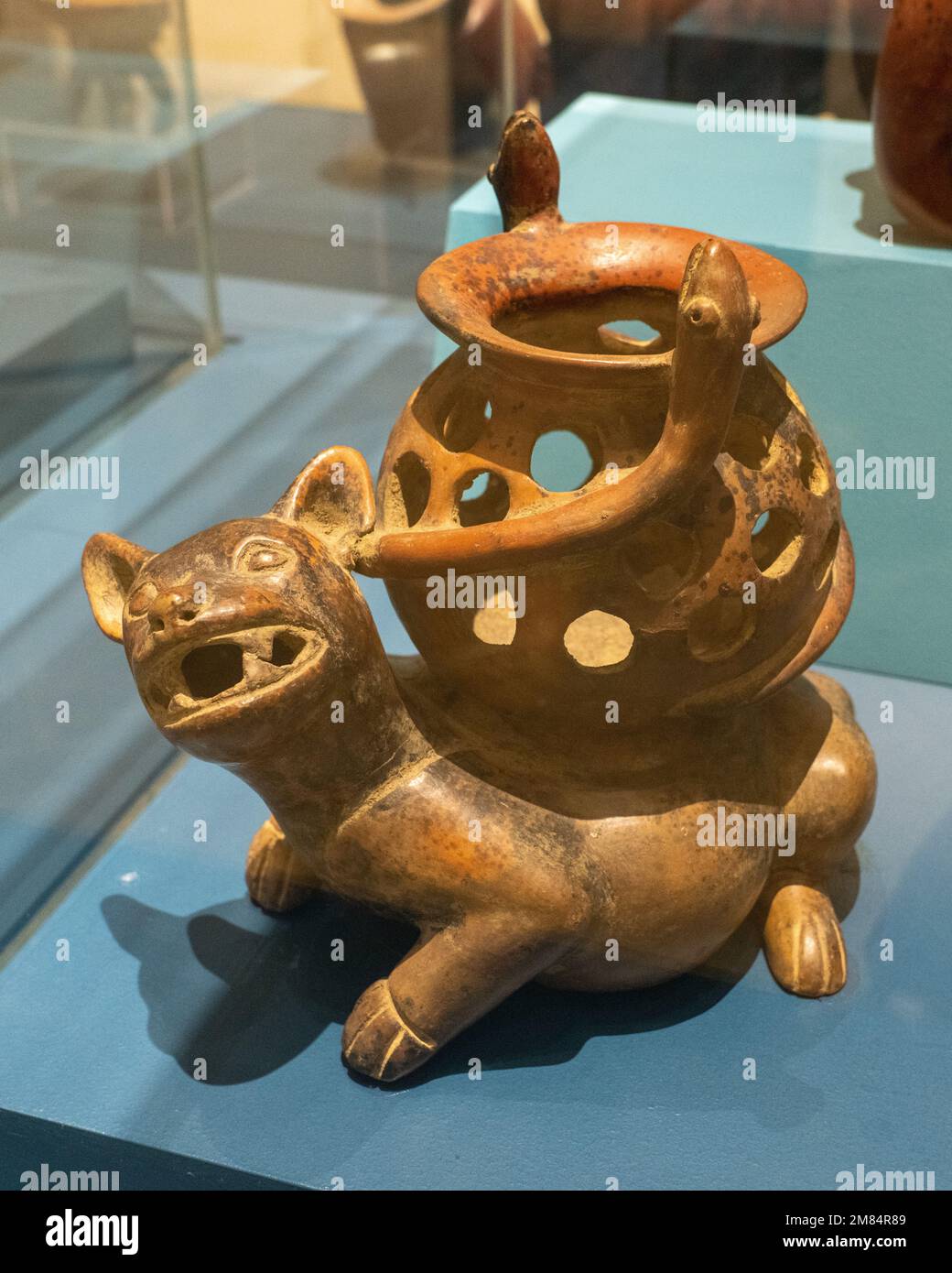 Pre-Hispanic ceramic figurine in the shape of a dog with a pot & a ...