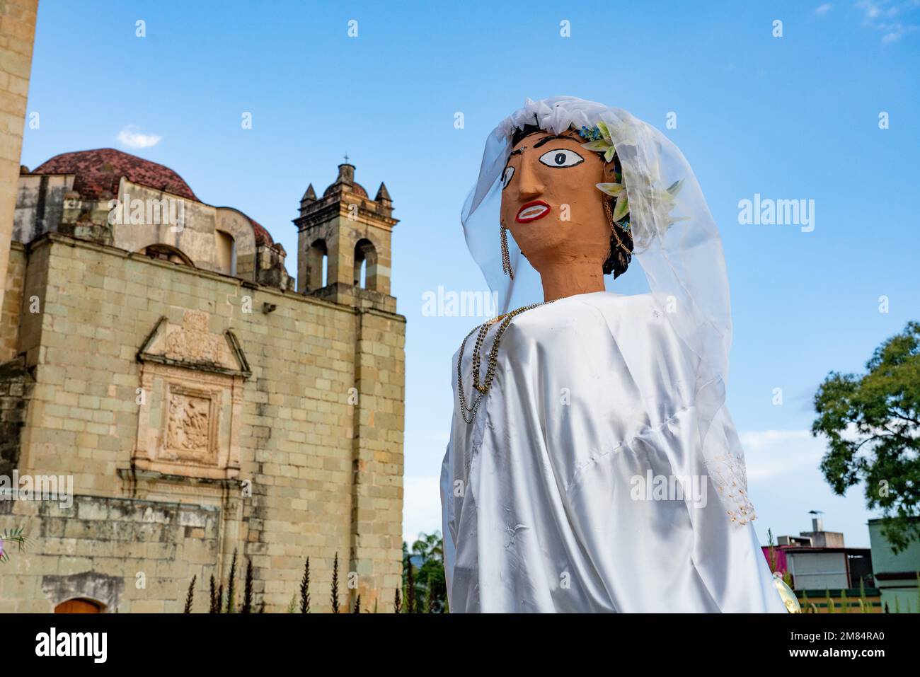 A giant bride puppet dances at a wedding celebration parade at the ...