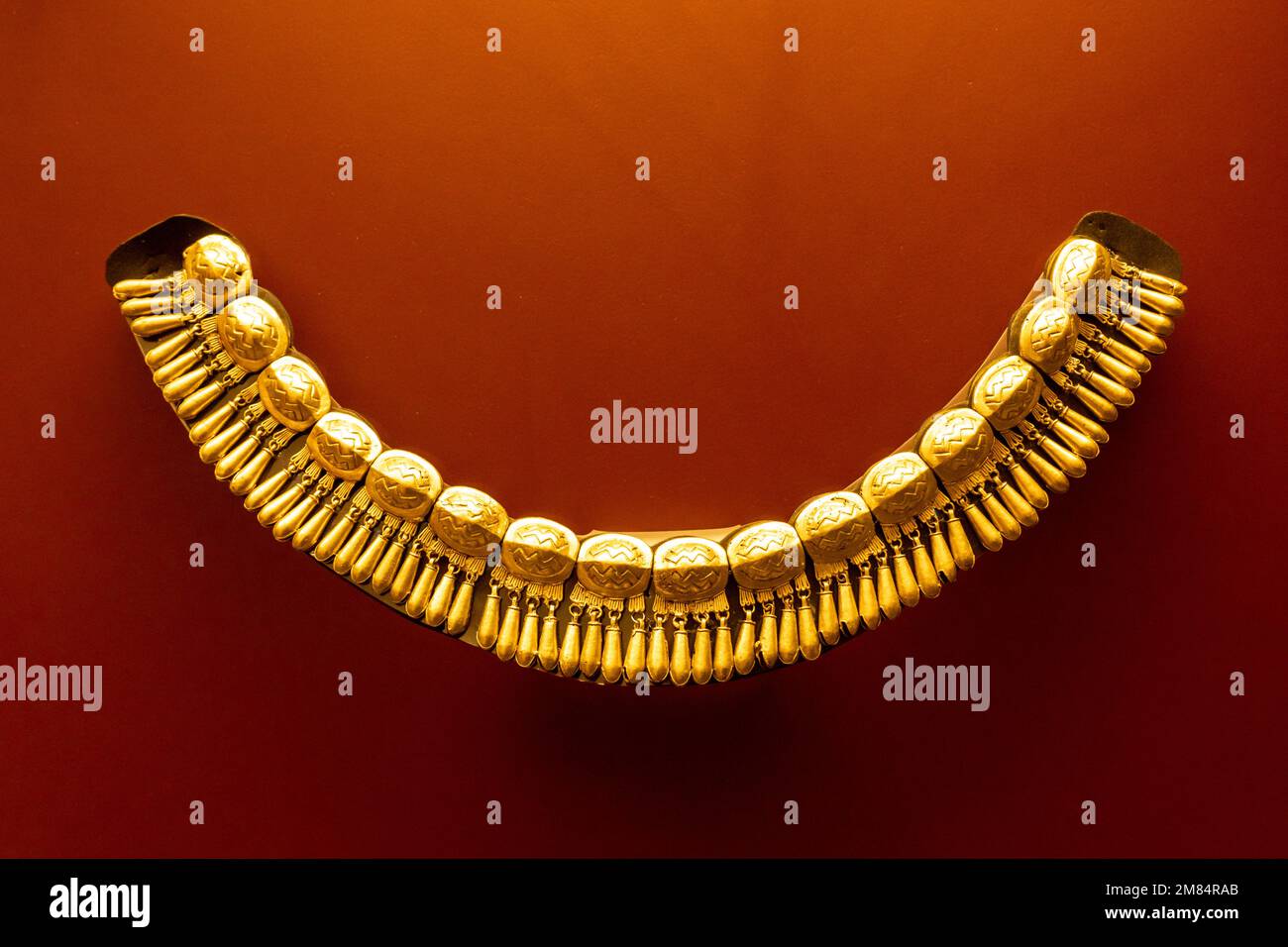 Gold tortoise shell beads on a necklace with bell rattles. Museum of ...