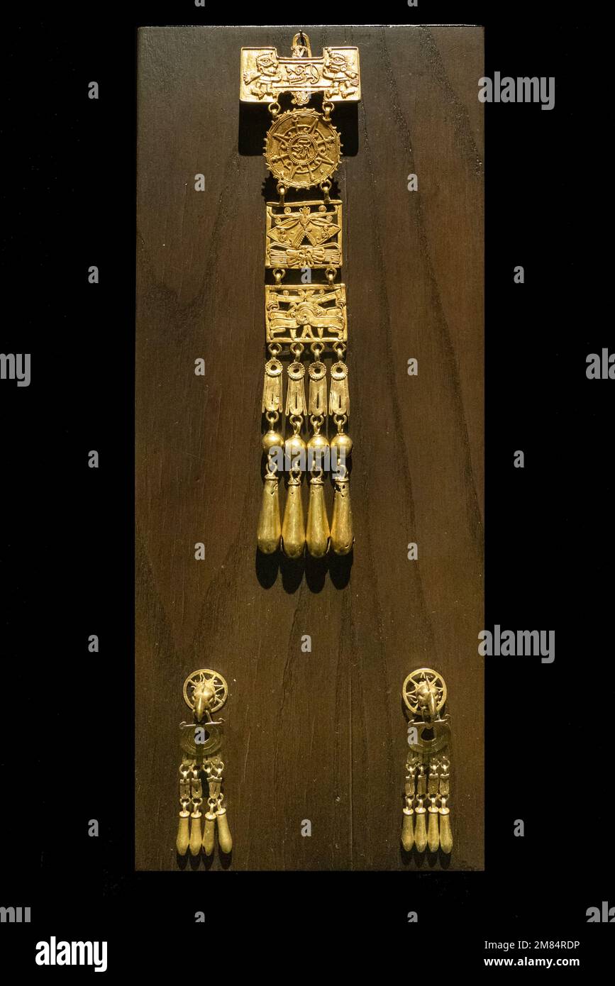 Gold pectoral showing the order of the universe with earrings from Tomb ...