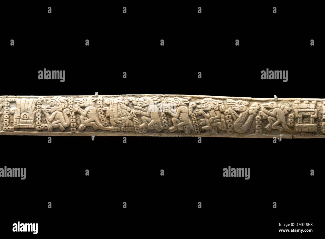Bone with carved figures used for ritual purposes. Museum of Cultures ...