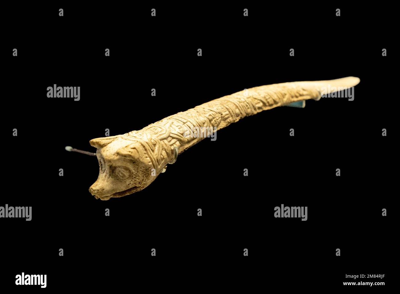 Bone with carved figures used for ritual purposes. Museum of Cultures ...