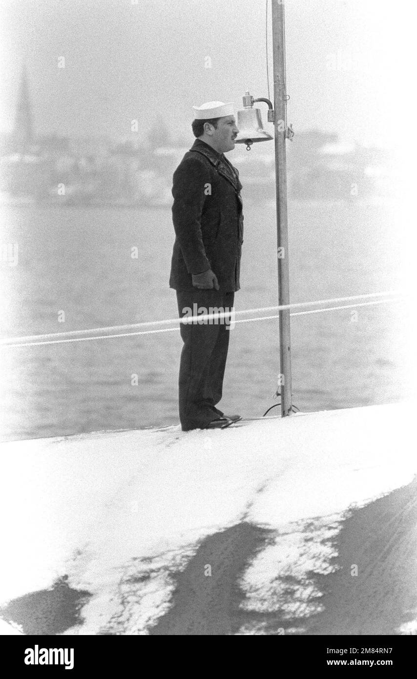 Quartermaster 2nd Class Abbott stands by near the ship's bell during ...
