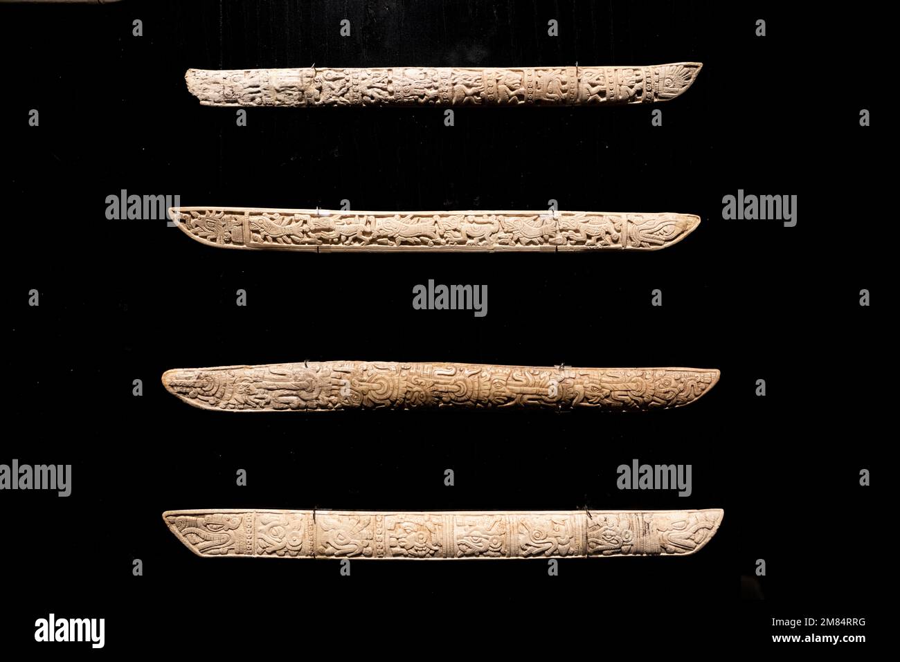 Bone with carved figures used for ritual purposes. Museum of Cultures ...