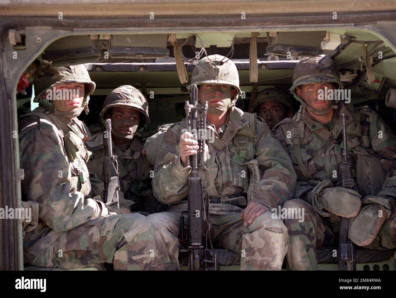 Infantrymen of the 2nd Bn., 41st Inf., 2nd Armored Div., sit inside an ...