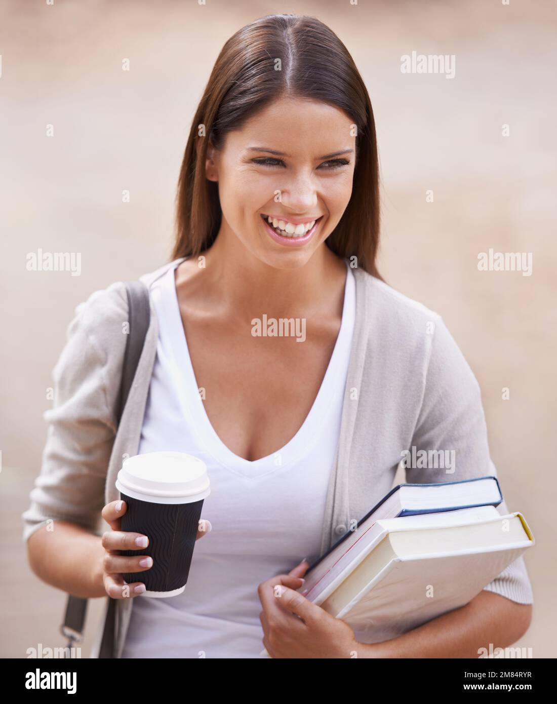 Excited for her next class. A gorgeous university student enjoying a ...