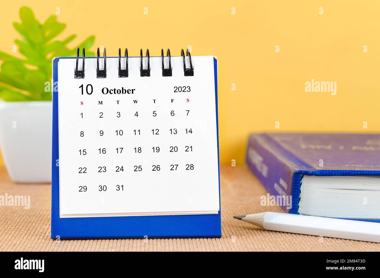 A October 2023 desk calendar with a book Stock Photo - Alamy