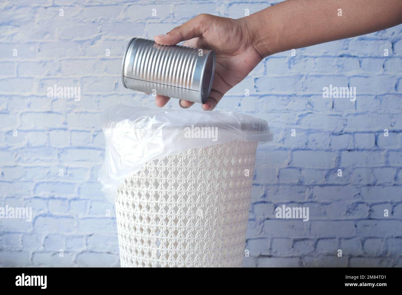 throwing tin container in a garbage bin Stock Photo - Alamy