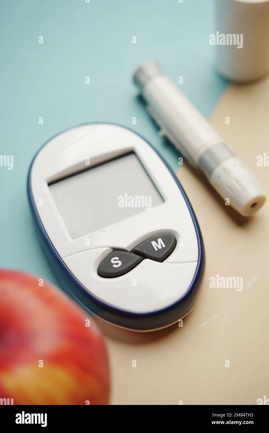 diabetic measurement tools, apple on table Stock Photo - Alamy