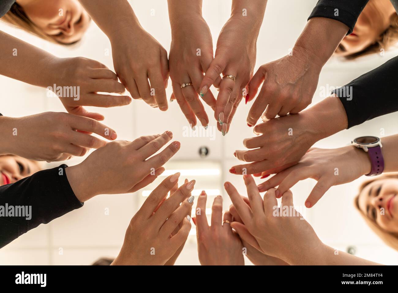 Team of people holding hands. Group of happy young women holding hands ...