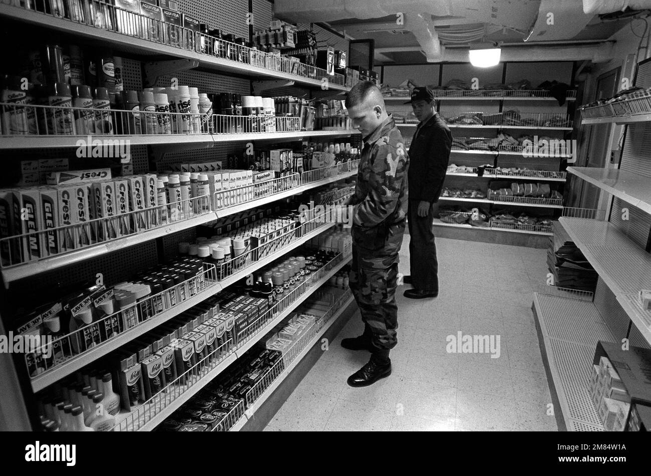 Crew members pick up personal supplies in the aft ship's store of the ...