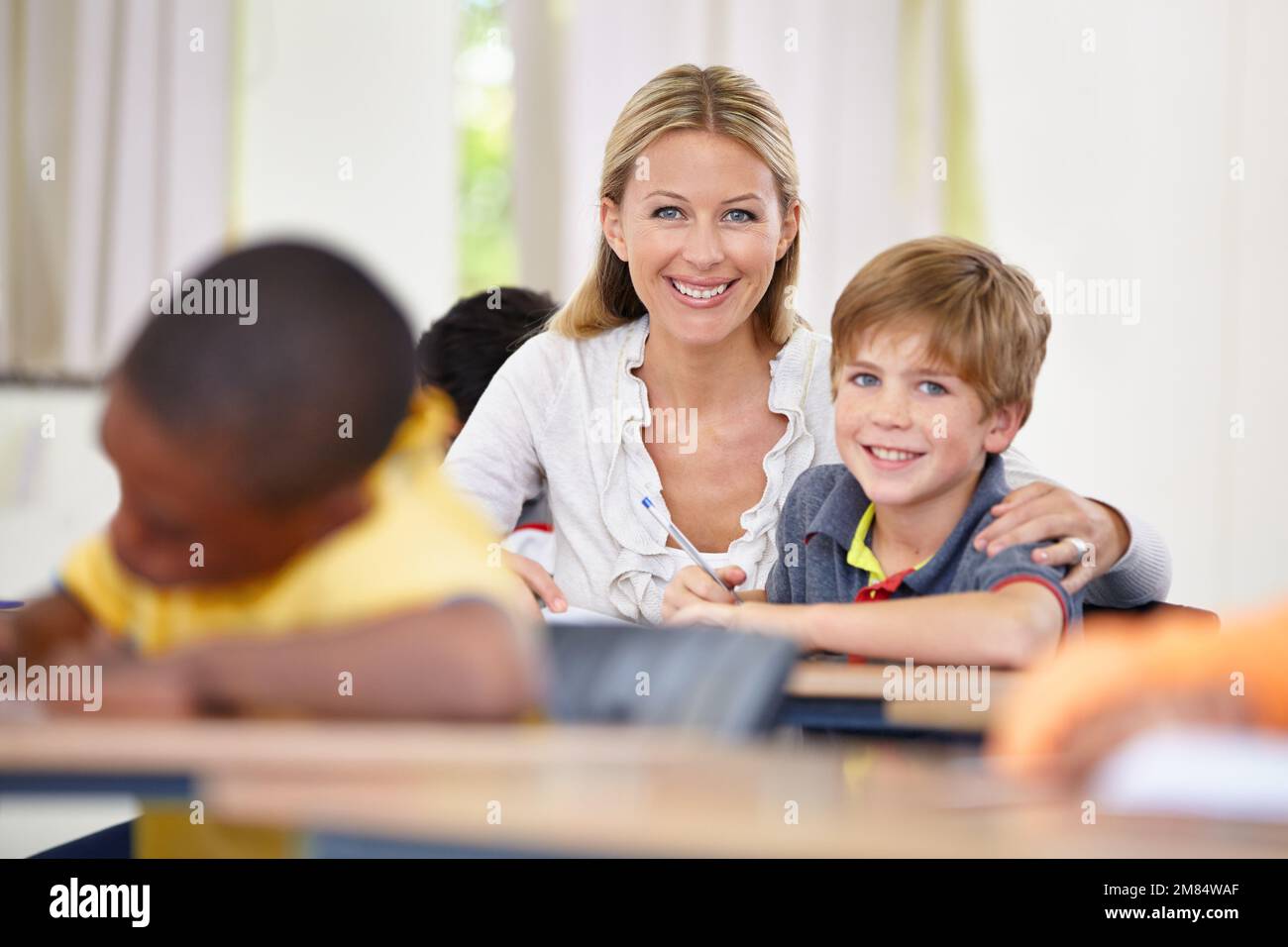 Shes a dedicated educator. Portrait of a smiling teacher with her ...