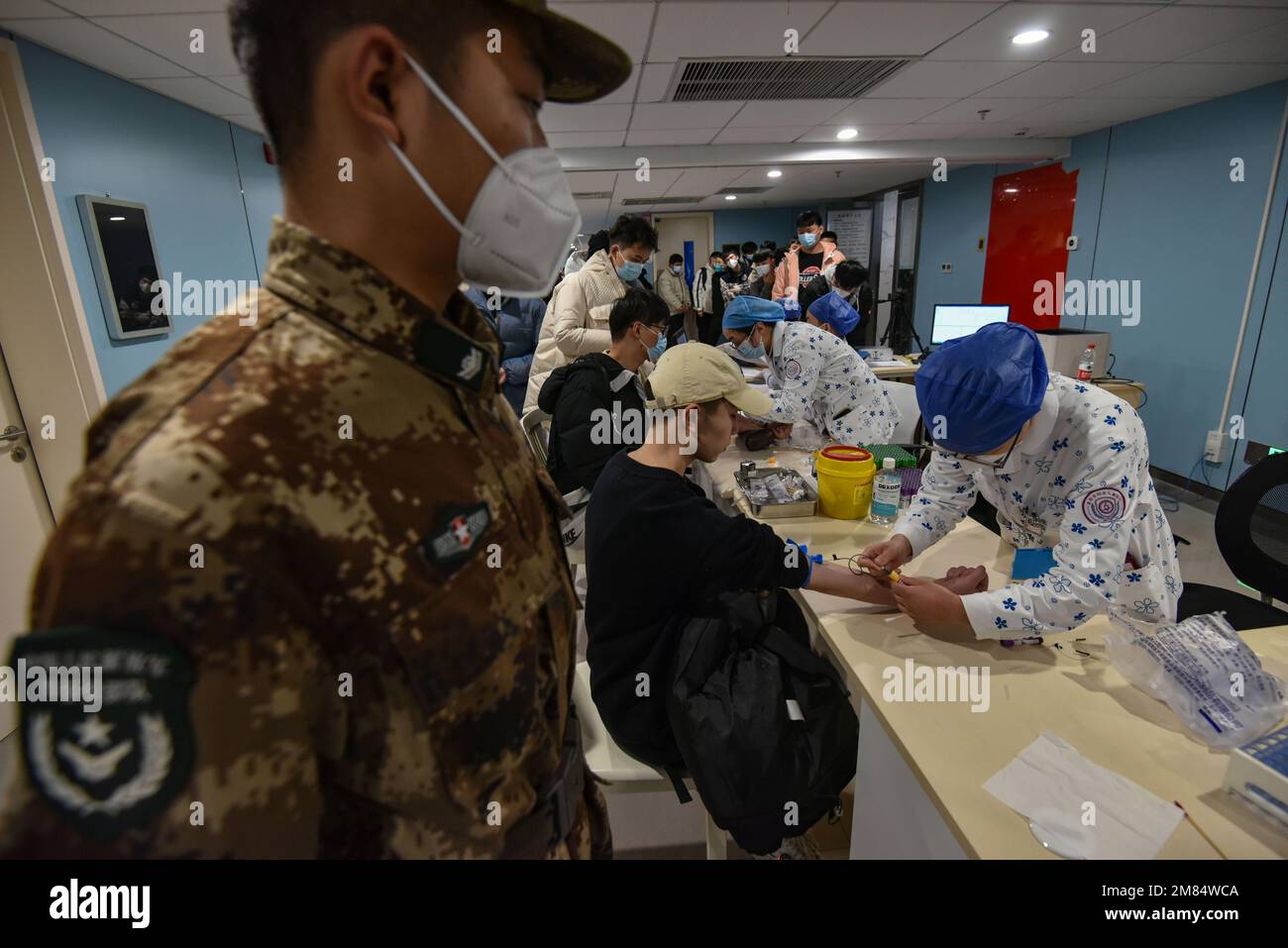 Fuyang, China. 12th Jan, 2023. A doctor examines the nose of a young ...