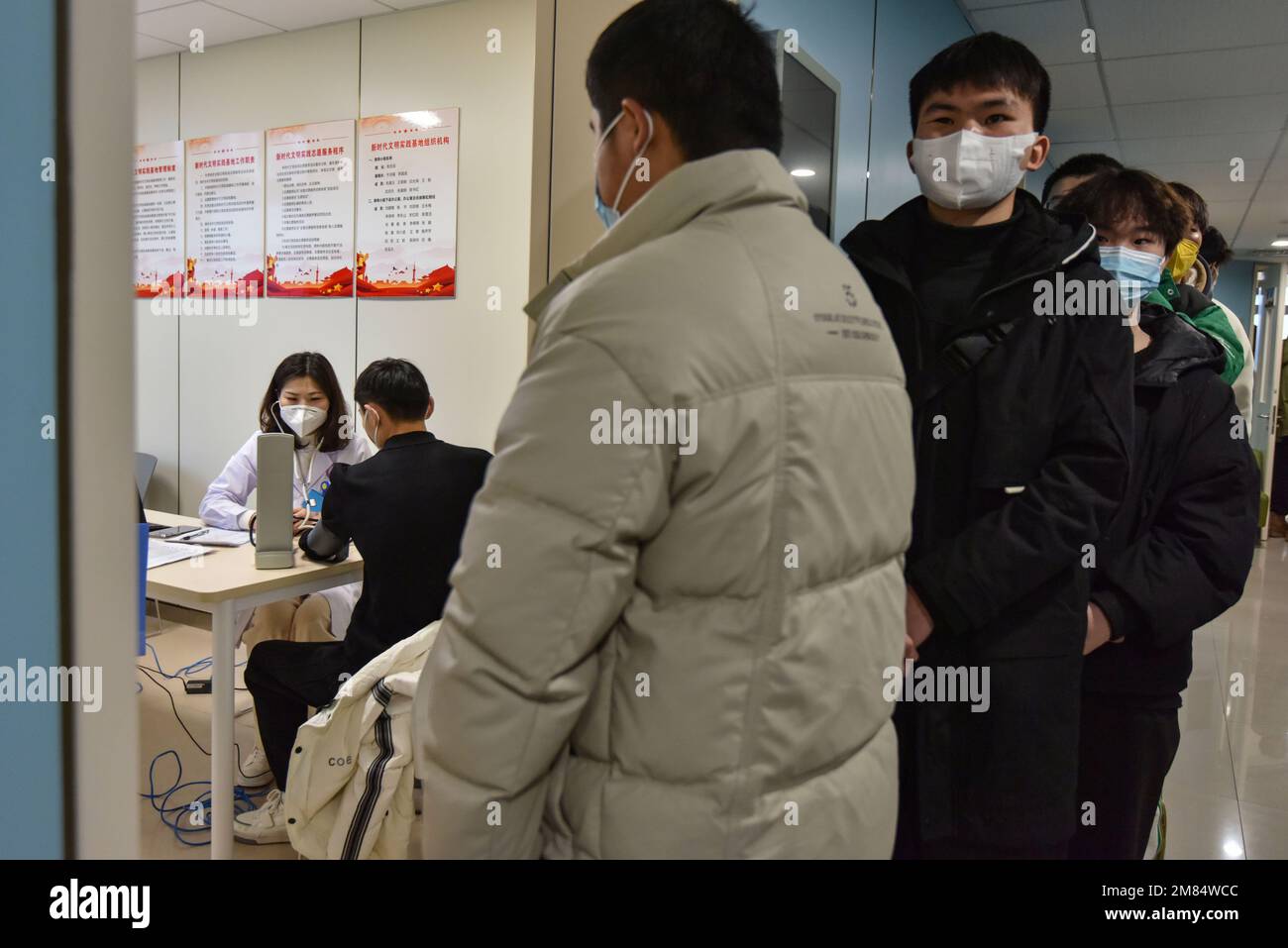 Fuyang, China. 12th Jan, 2023. A nurse draws blood from a young man for ...
