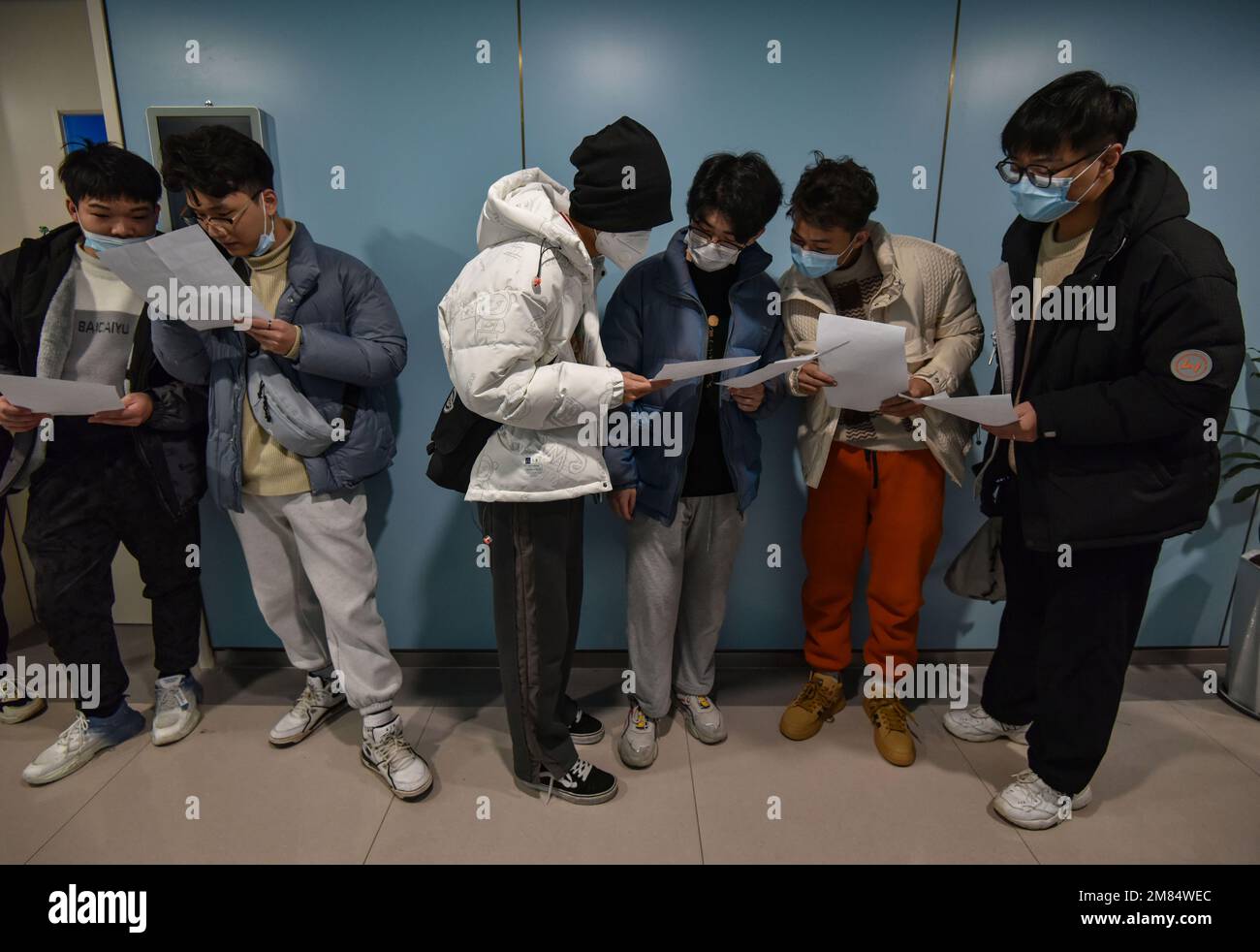 Fuyang, China. 12th Jan, 2023. Young men line up with their physical ...