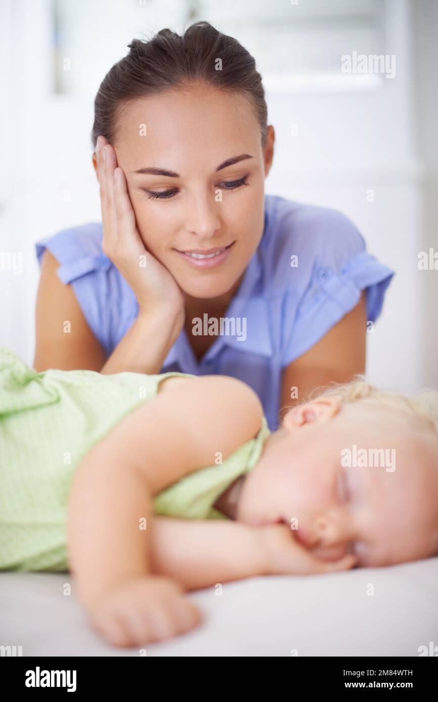 No love stronger than a mothers. a mother watching over her sleeping ...