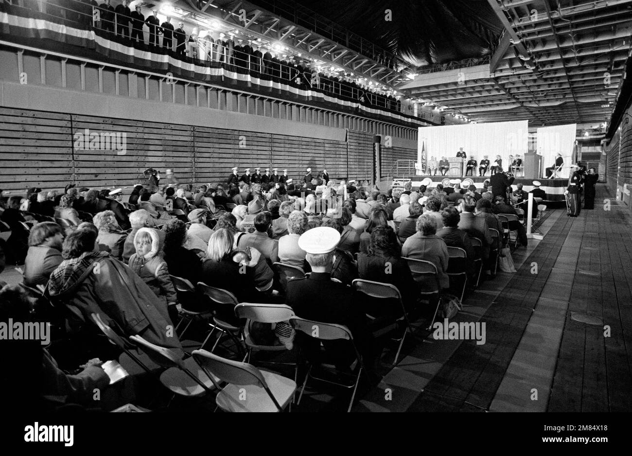 Guests are seated in the well deck during the commissioning of the dock ...