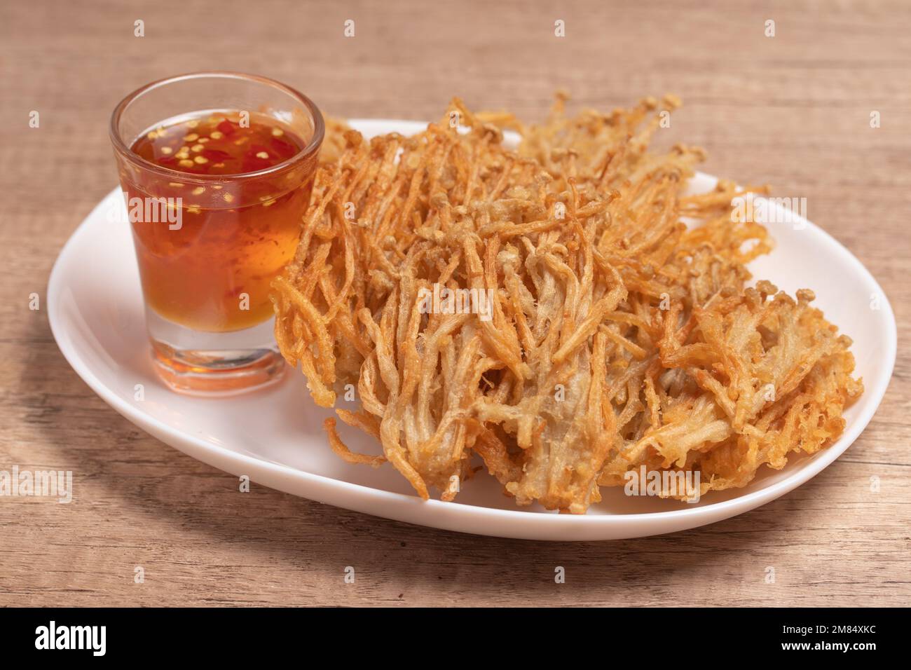 Deep-fried golden needle mushrooms with sweet and spicy sauce Stock ...