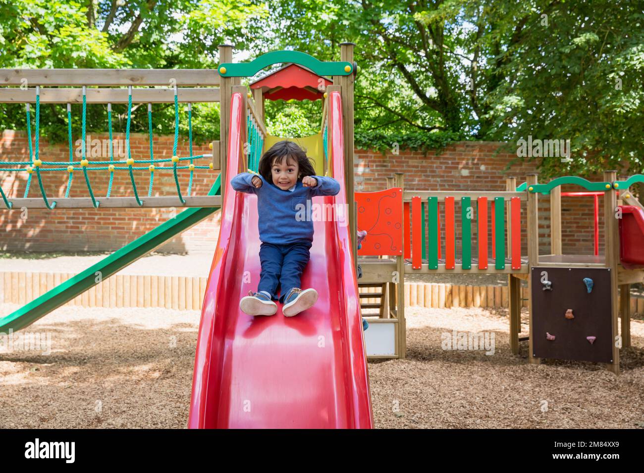 Child playing on outdoor playground Stock Photo - Alamy