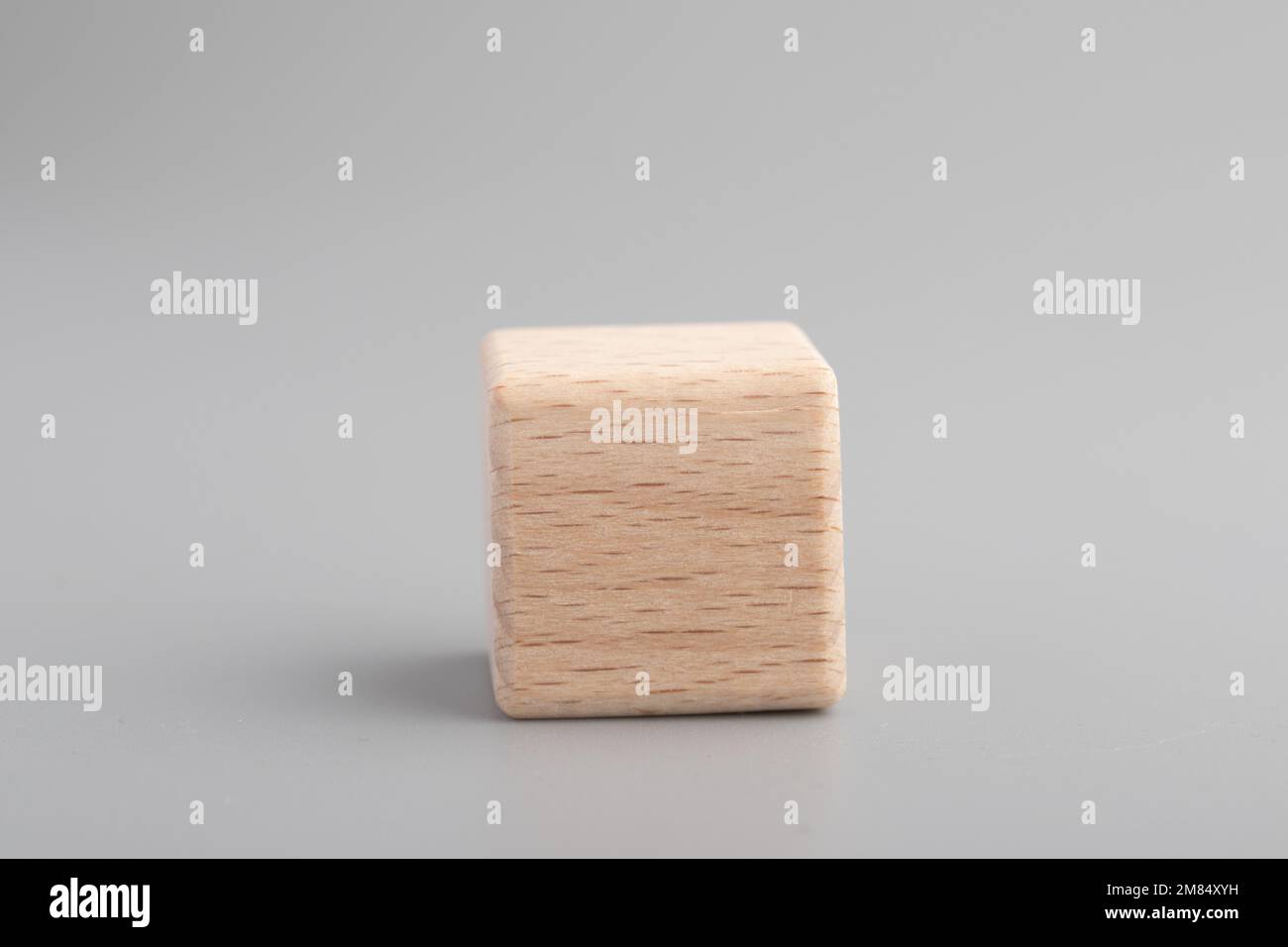 Simple empty wooden dice, one blank cubes made of wood with one central ...