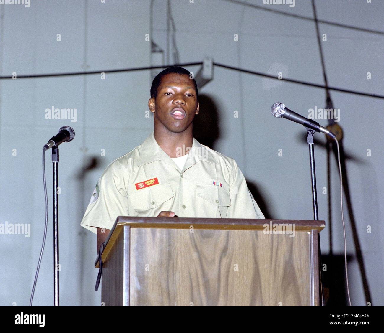 A Marine addresses crew members and guests during a Black History Week ...
