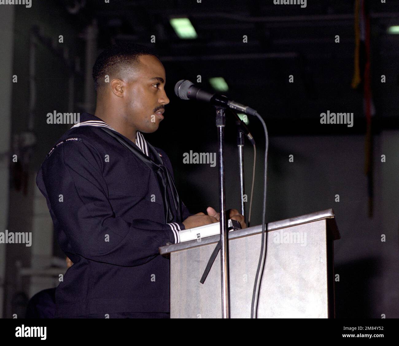 A sailor addresses crew members and guests during a Black History Week ...