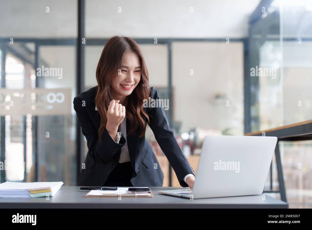 Successful Asian business woman achieving goals. Excited woman ...