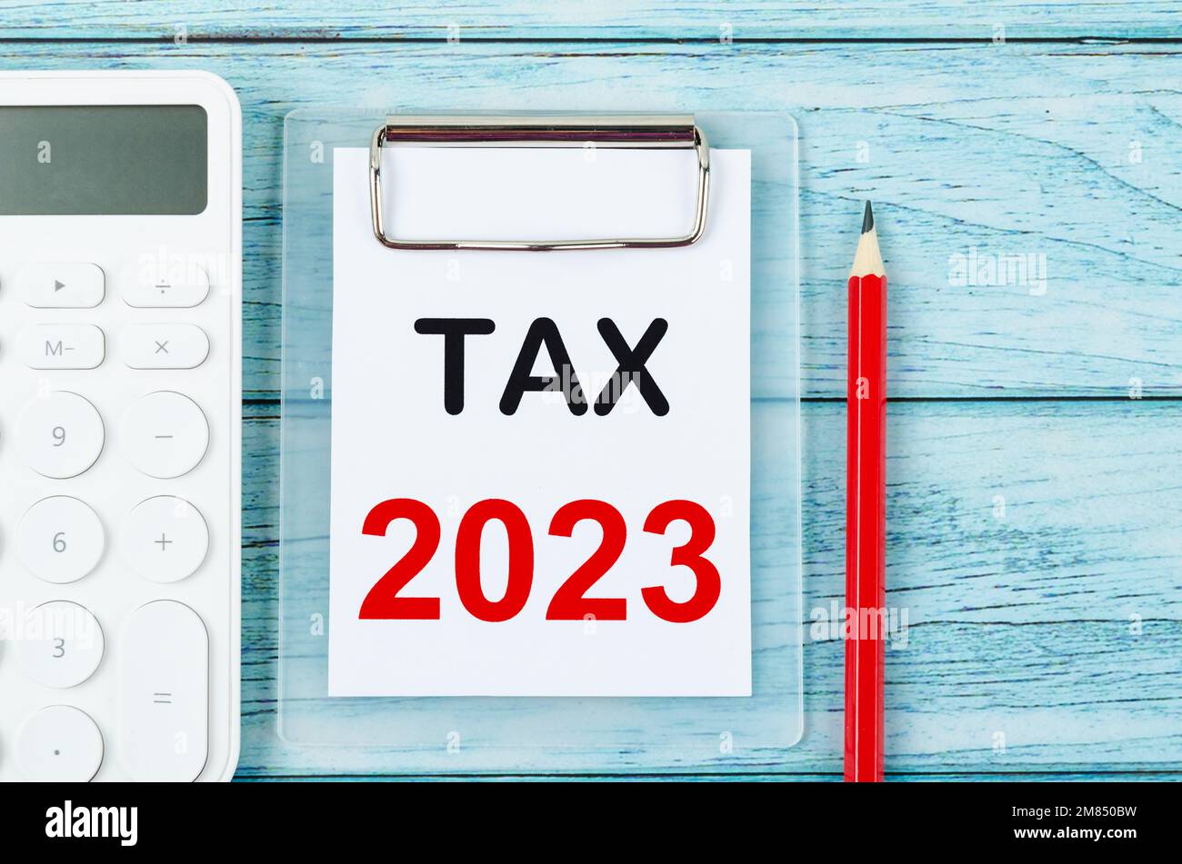 Tax 2023 text on clipboard with calculator on wooden background. 2023 ...
