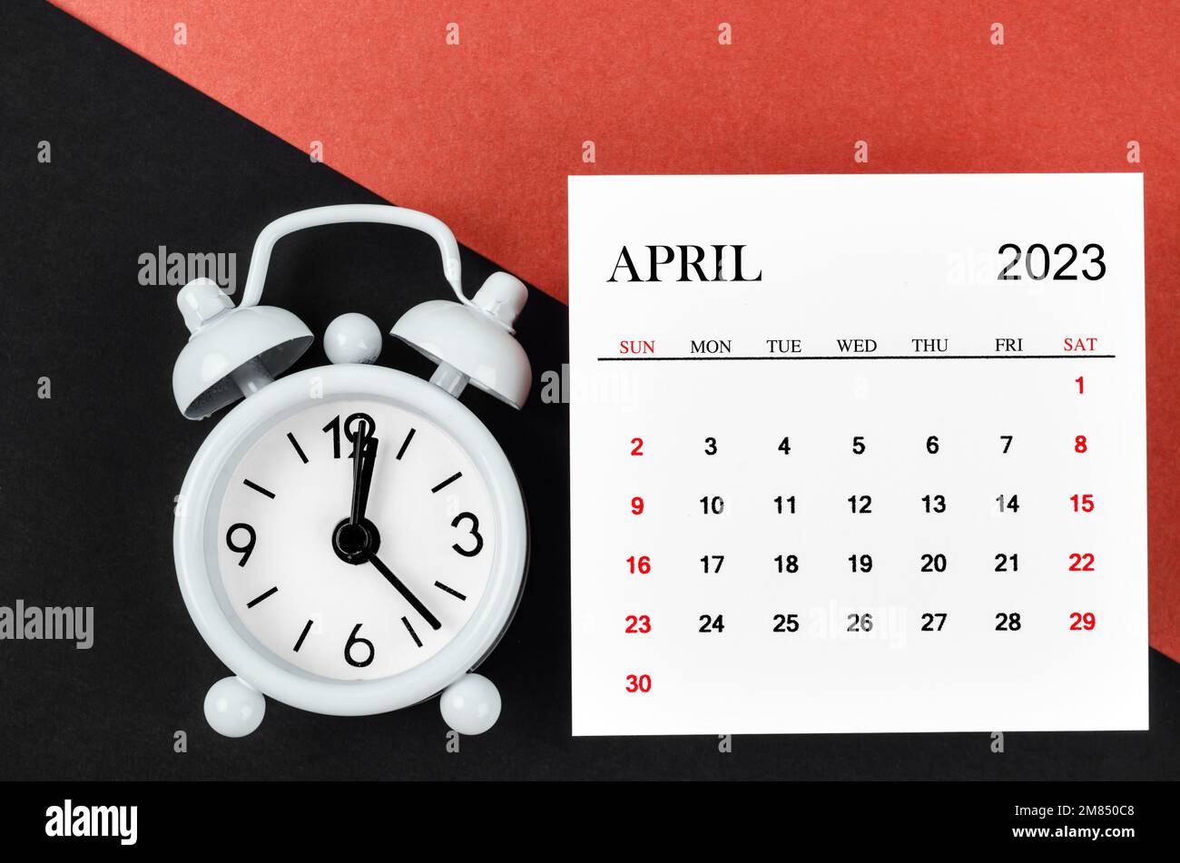 April 2023 Monthly calendar year with alarm clock on red and black ...