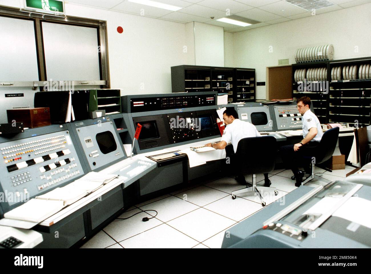 Air Force personnel monitor the Autodin Switching Center console. Base ...