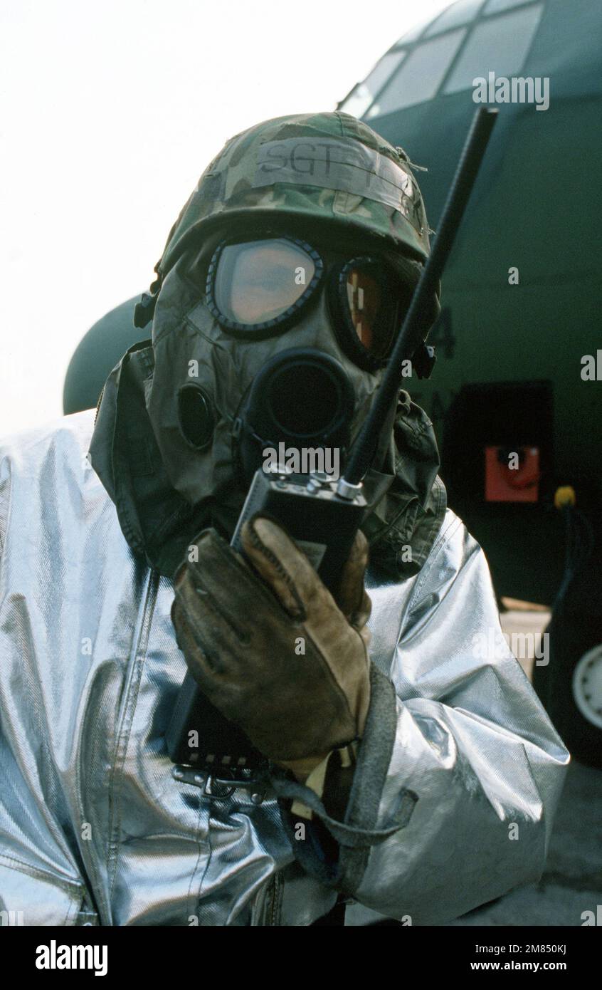 A fireman, wearing a proximity suit and an M-17 nuclear-biological ...